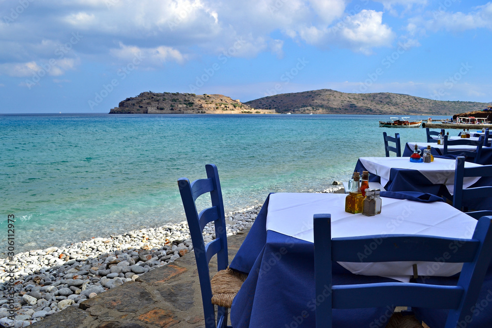 Cozy tables of street cafe in the shade. Tables with tablecloths. On ...