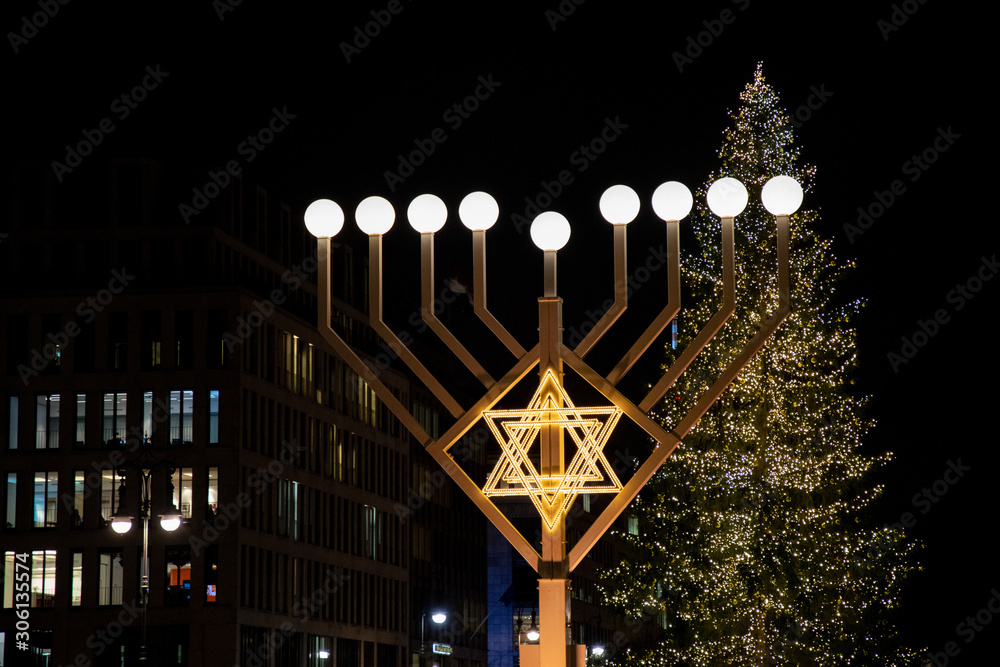 Huge illuminated menorah with round lamps and lighted Jewish symbol ...