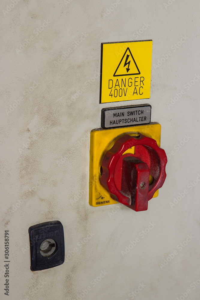 Foto de 400V AC electricity switch bright red and yellow on industrial ...