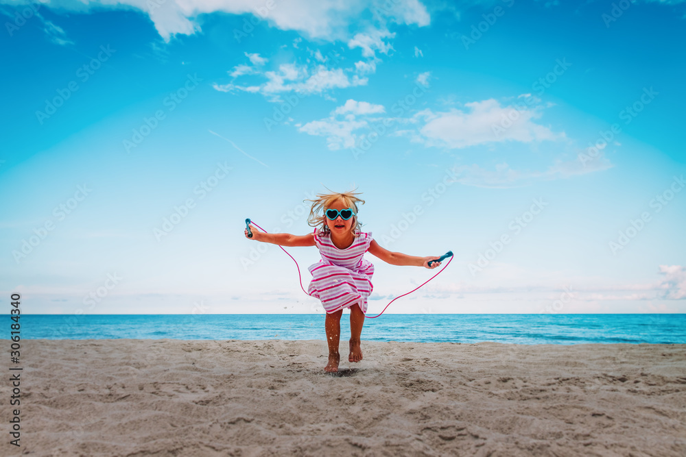 happy cute little girl jumping with rope on beach vacation Stock Photo ...
