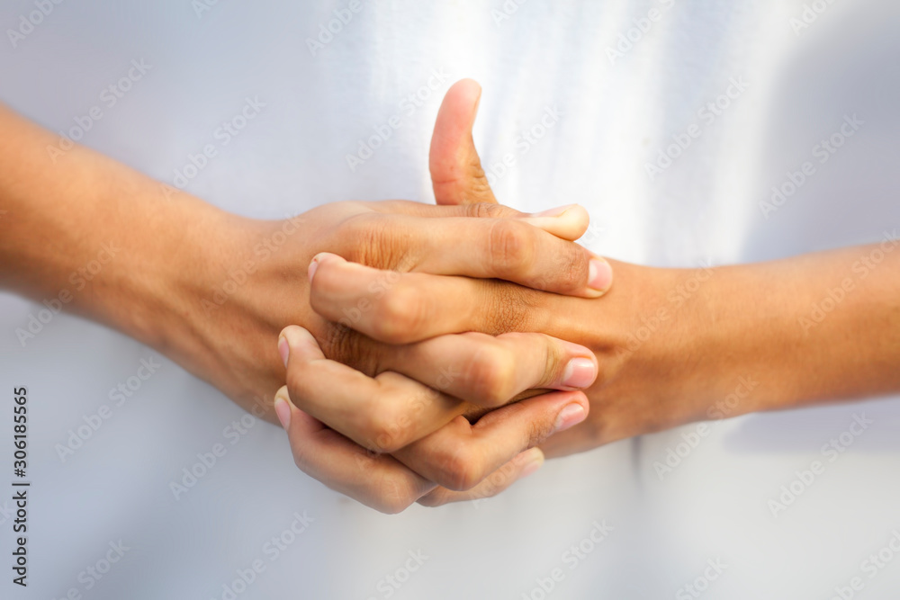 Isolated interlace fingers of both hands and extending up one finger ...