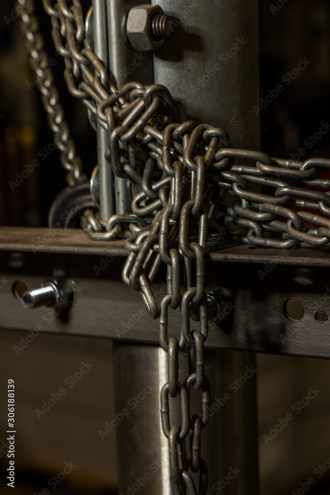 Metal chains wrapped around steel structure going both up and across in ...