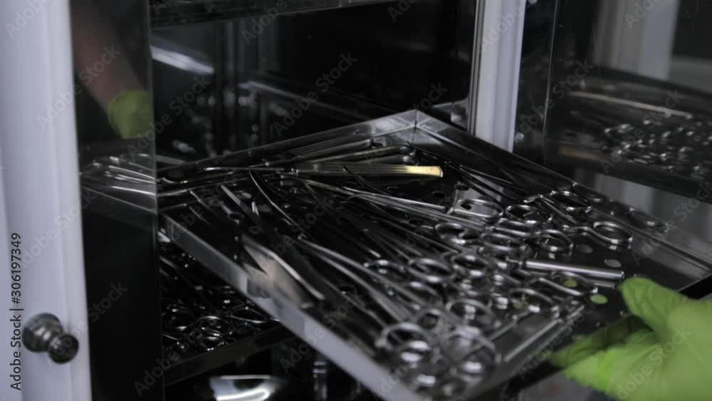 Sterilization of medical instruments. Close up shot of nurse taking ...