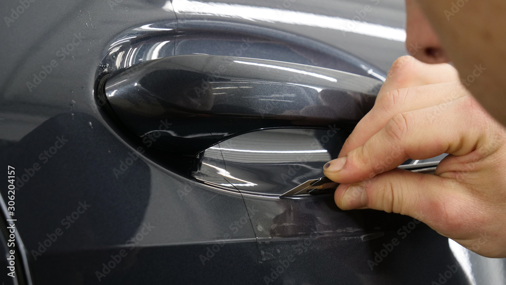 Fotka „Close up to PPF installation process on a front headlight and ...