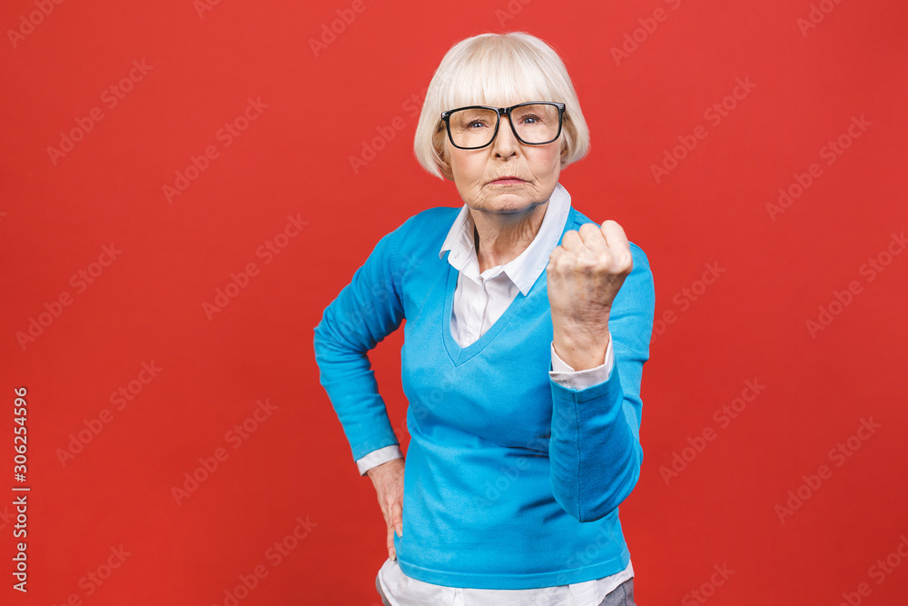 Portrait of angry grey haired old strict senior woman wearing glasses ...