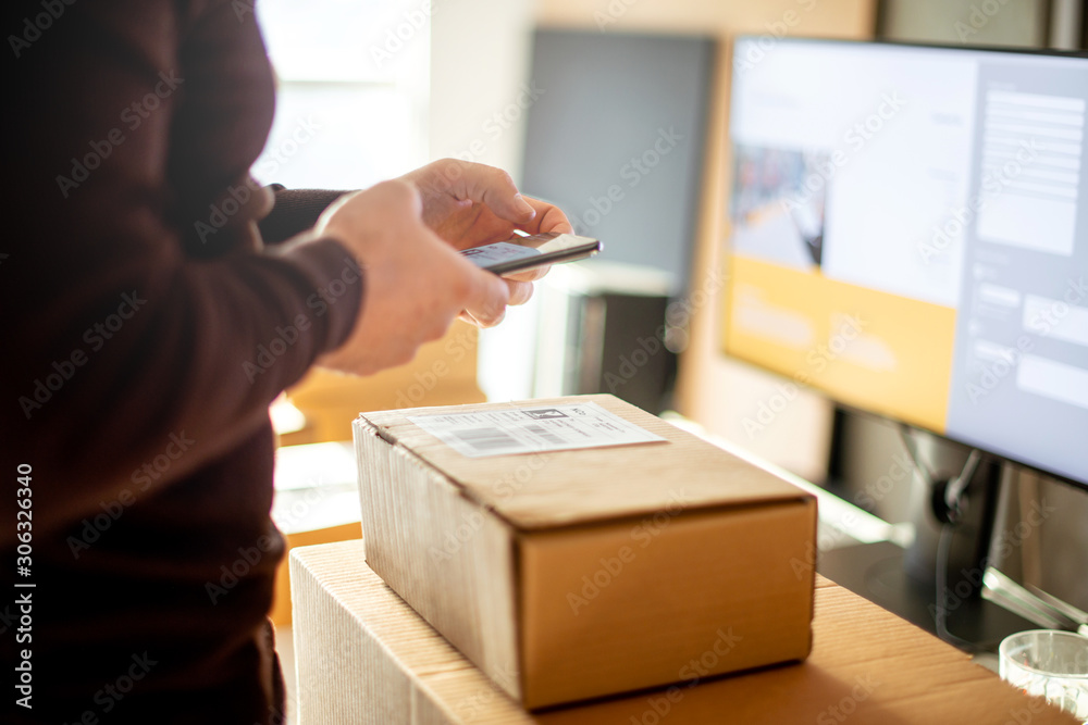 Delivery service, scanning a shipping label Stock Photo | Adobe Stock
