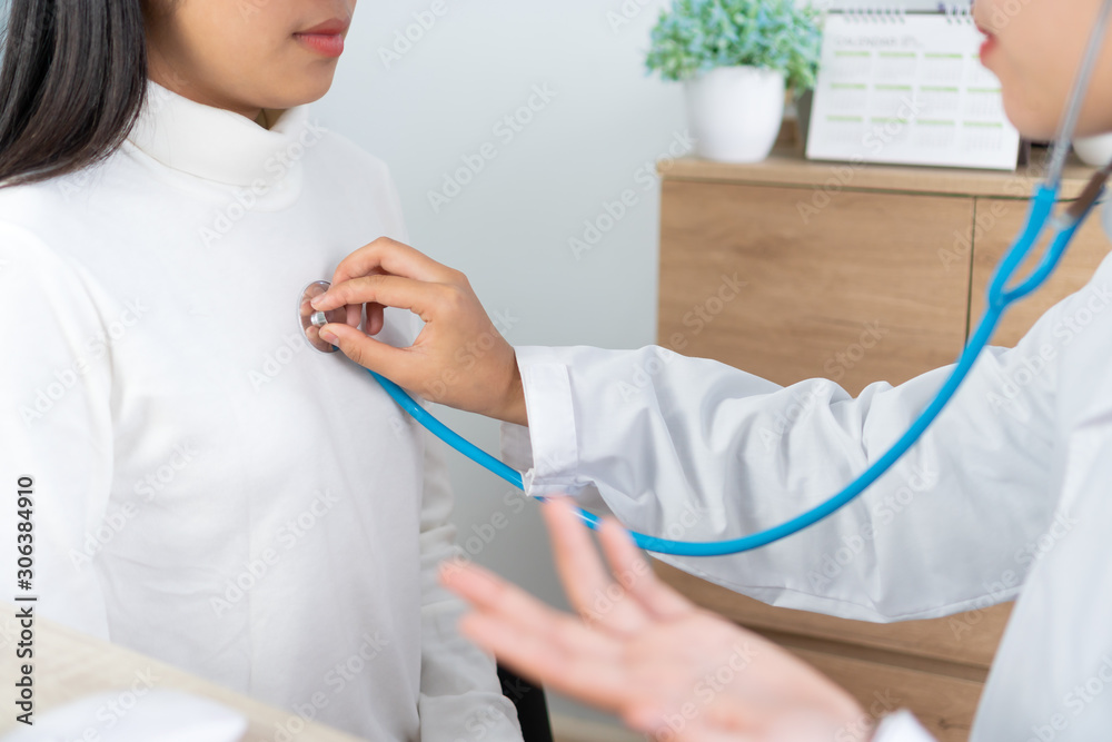Doctor Female checking heart patient's vitals by stethoscope, Asian ...