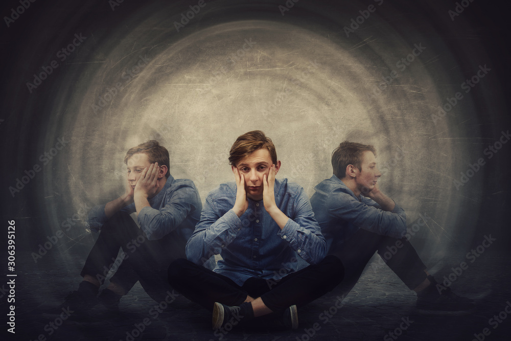 Teenage guy seated on the floor suffer split emotions into three ...