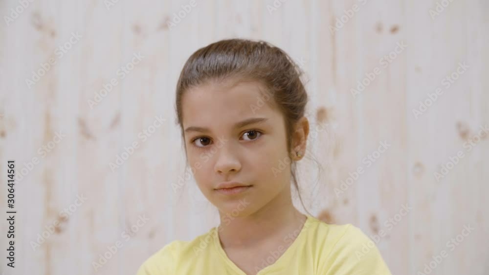 Girl with disgusted facial expression looking at camera. Portrait of ...