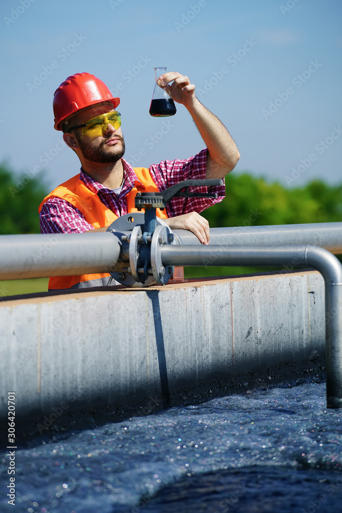 An engineer controlling a quality of water ,aerated activated sludge ...