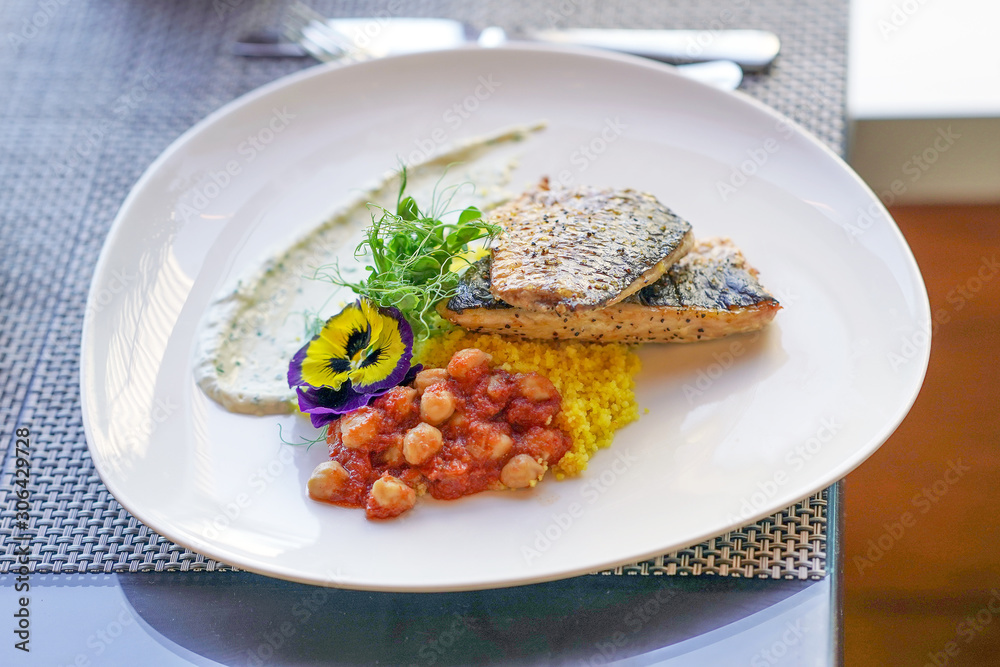 Closeup perfectly executed mullet fillet steak with crispy fish skin ...