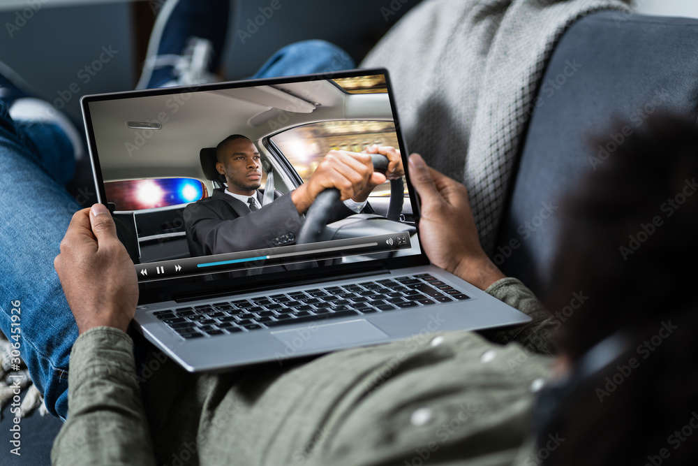 Man Watching Thriller Movie On Laptop Stock Photo | Adobe Stock
