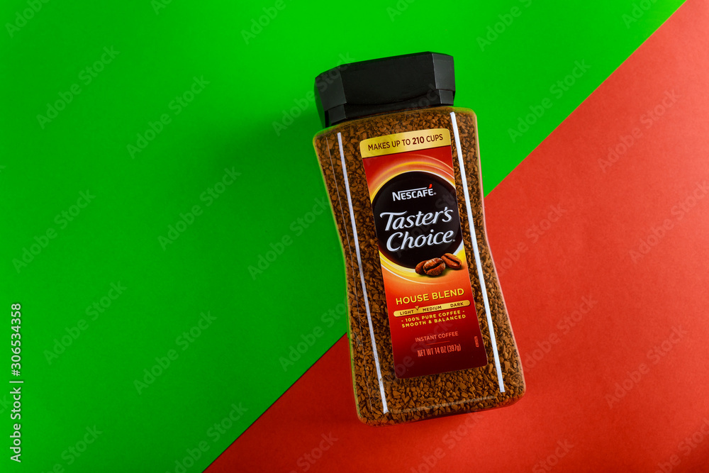 Jar of instant Nescafe coffee in the green and red background. Stock ...