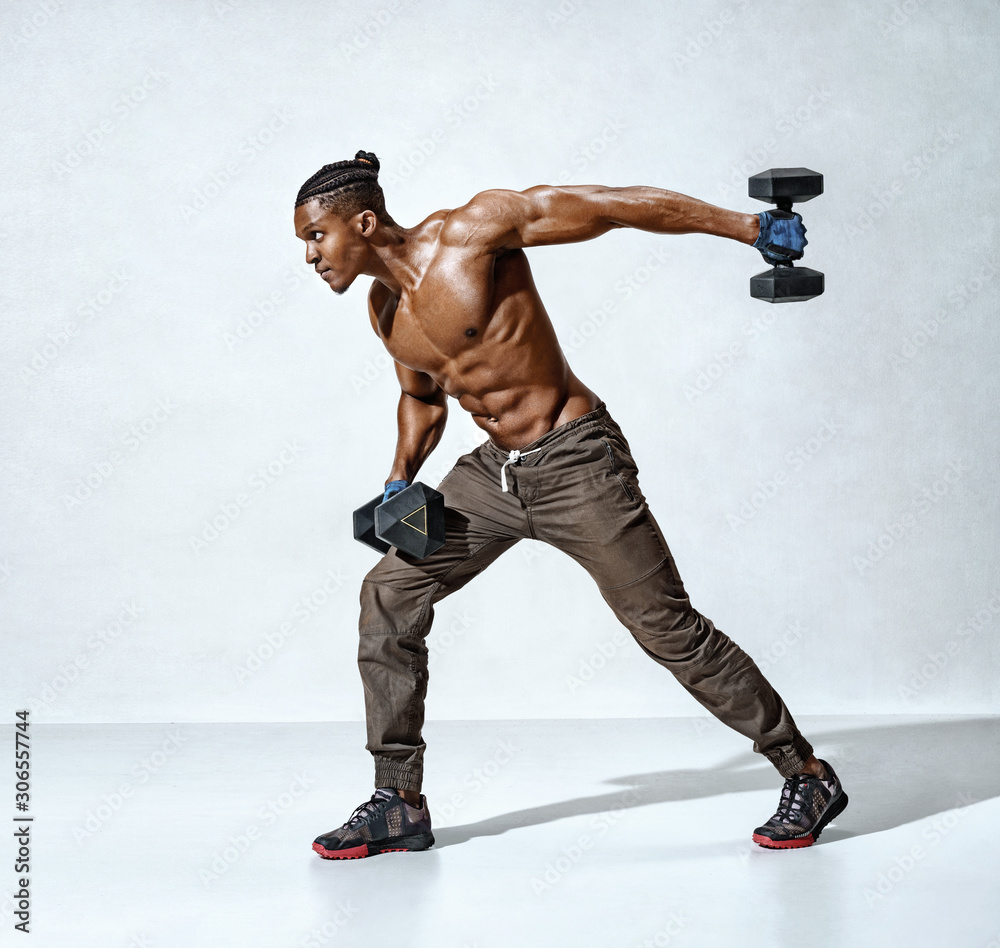 Athletic man doing exercise for arms with dumbbells. Photo of muscular ...