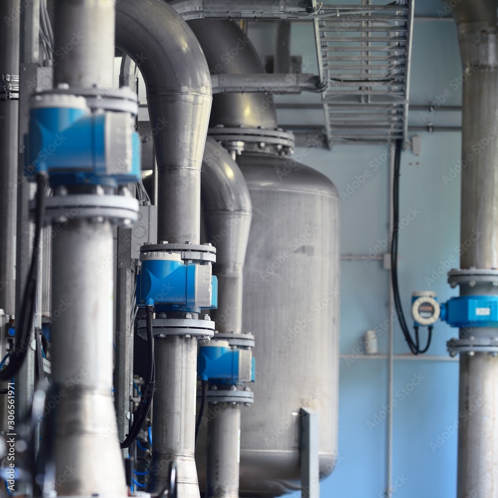 Large industrial water treatment and boiler room. Piping, servo ...