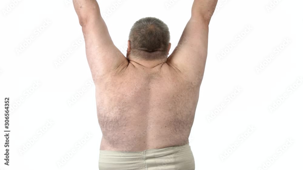 Fat man training his body, back view. Obese guy lifting two dumbbells ...