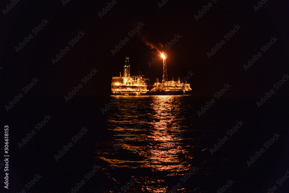 Night view of FPSO tanker vessel near Oil Rig. Offshore oil and gas ...