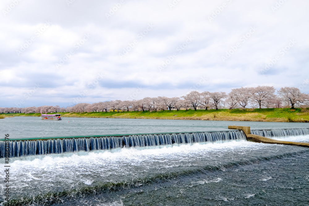 The dam across Shiroishi River with water waving and splash water ...