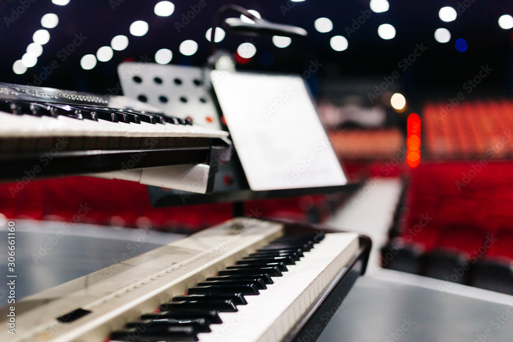 keyboard at concert stage. Background with bokeh. Musical background ...
