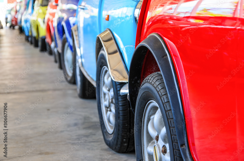 Colorful cars standing in line on parking cars, different colored cars ...
