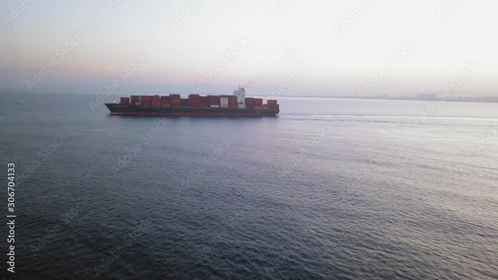 Large container ship at sea, loaded with various container brands. ULCV ...