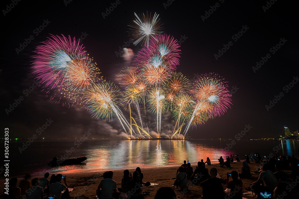 Colorful fireworks display over city on the beach. Firework celebration ...
