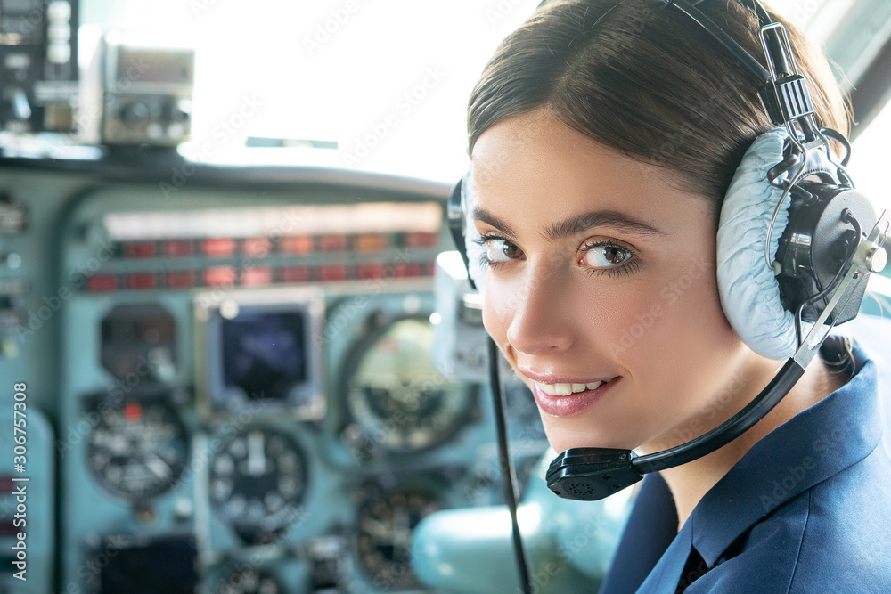 Pilot and Stewardess. Female pilot smiles and wishes a successful ...