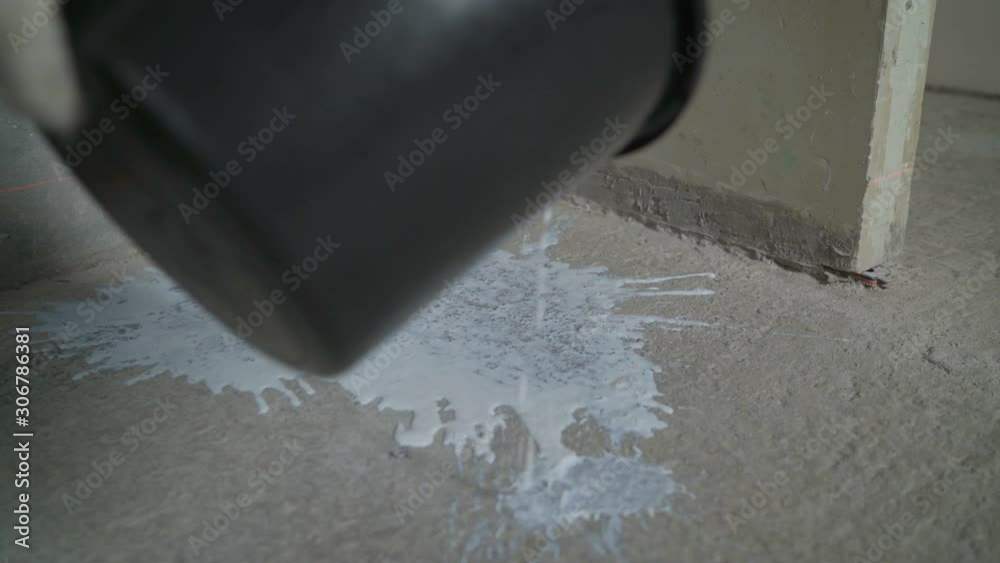 Priming the floor. Primer and concrete floor. The primer from the ...