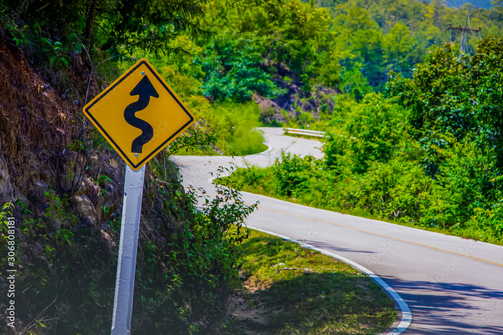Pathway devious concrete road and yellow sign meaning the pathway to ...