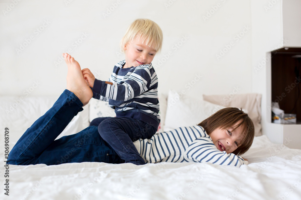 Brothers, playing at home, tickling feet laughing and smiling Stock ...