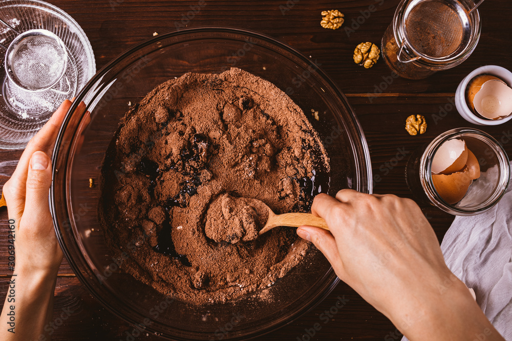 Woman's hands mixing melted chocolate and cocoa powder Stock Photo ...