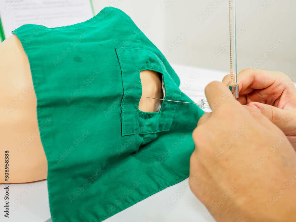 Closeup detail of a physician measuring the lumbar pressure of a ...