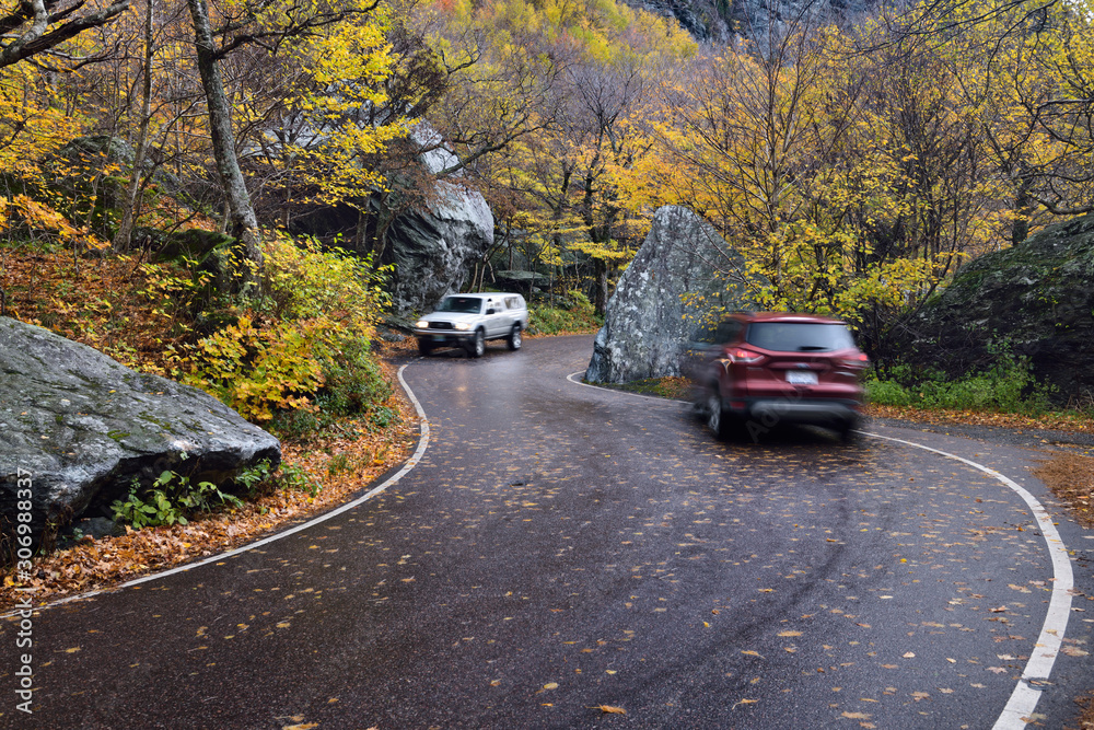Cars passing on Highway 108 pass through boulders at Smugglers Notch ...
