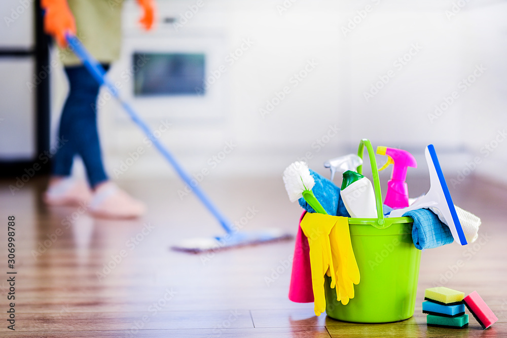 Bucket with cleaning items with modern kitchen and background. Washing ...