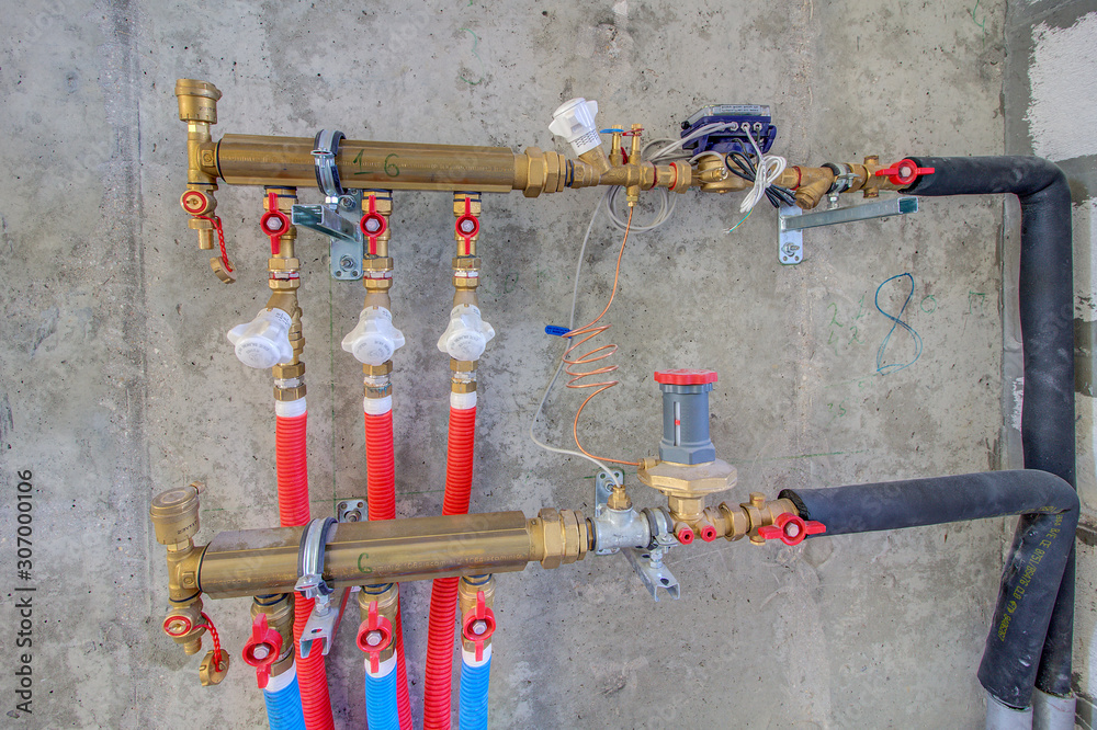 Piping and plumbing fitting on wall. Comb is pipe, branches (tees ...