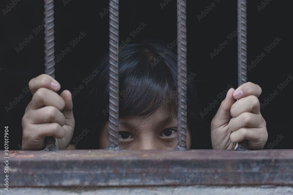 young girl hold cage with eye sad and hopeless, Human trafficking concept, human rights ...