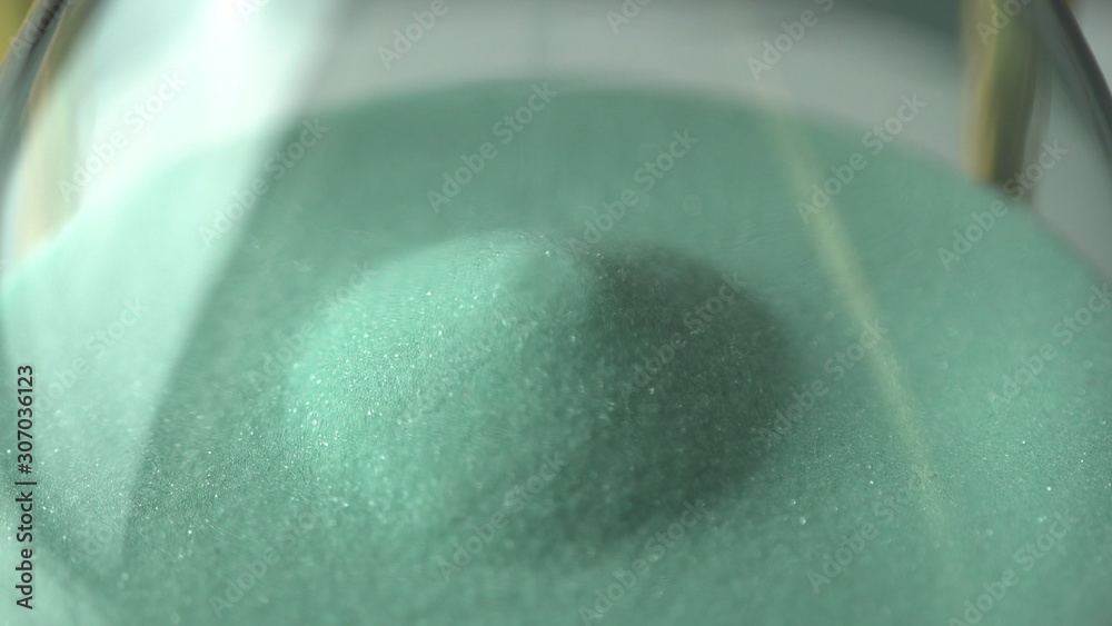 Extreme close up view of sand flowing through an hour glass. Super ...