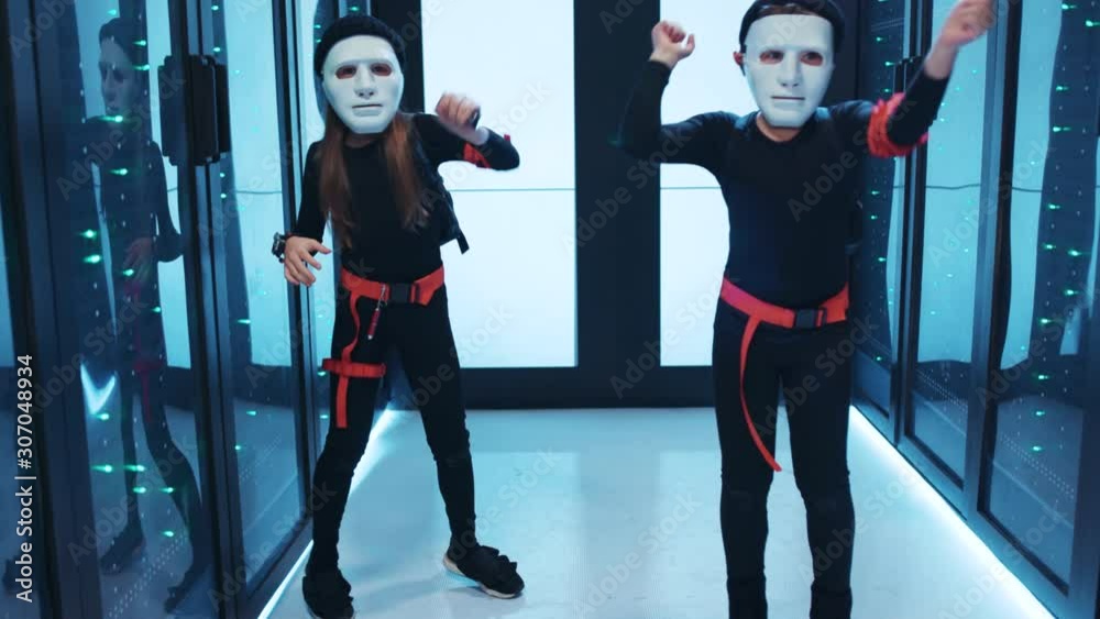 Excited young team of secret agents kids wearing anonymous masks ...