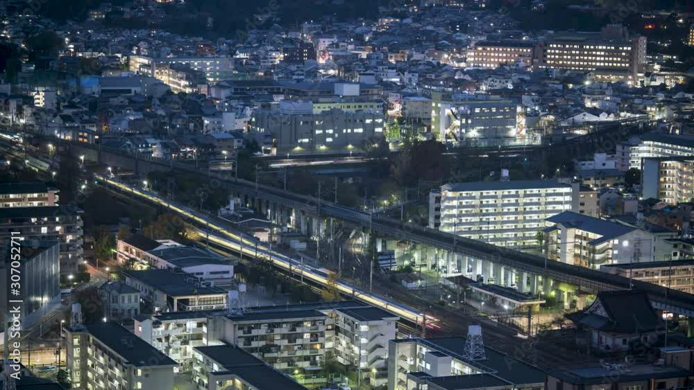 KYOTO, JAPAN, Bullet trains and commuter trains converging at twilight ...
