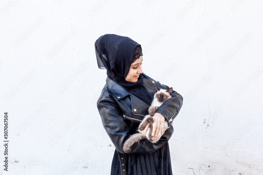 Beautiful middle-eastern Muslim woman plays with her exotic domestic ...