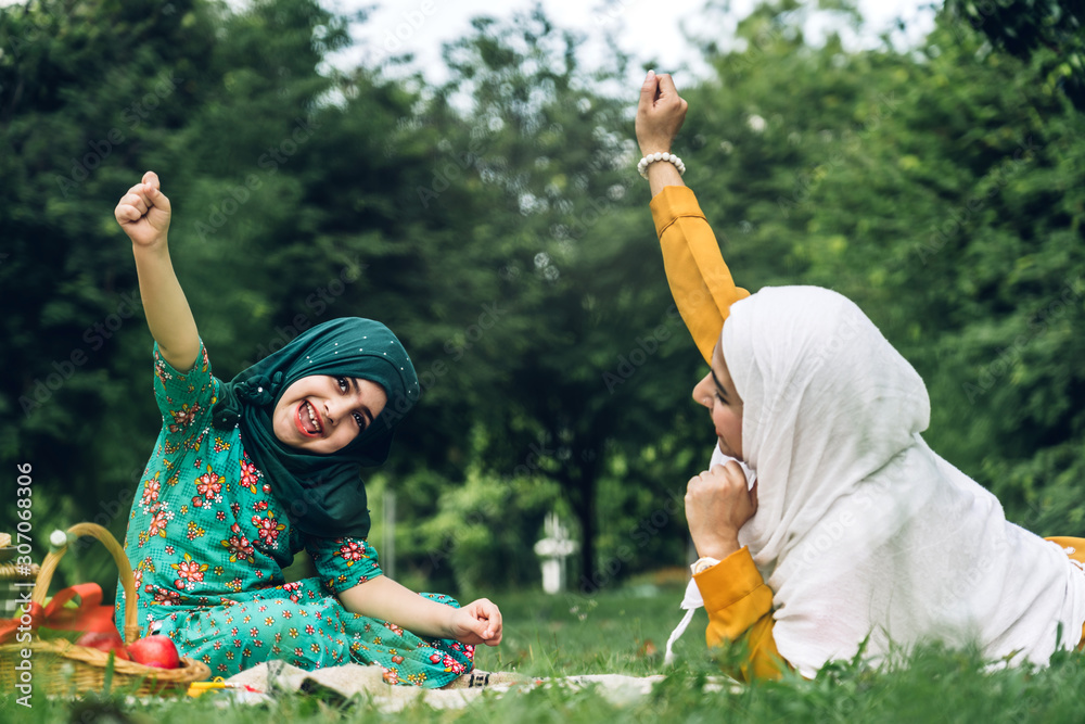 Portrait of happy muslim mother and little muslim girls child with ...