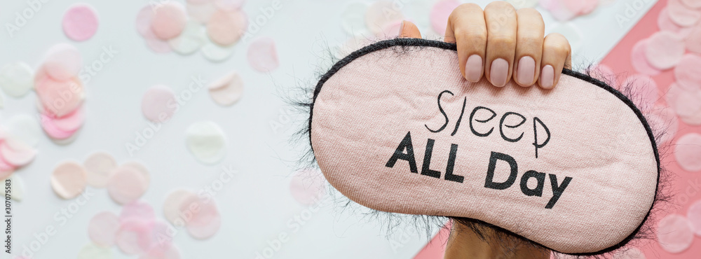 Healthy sleep concept. Female hand holding Sleeping mask on pink ...