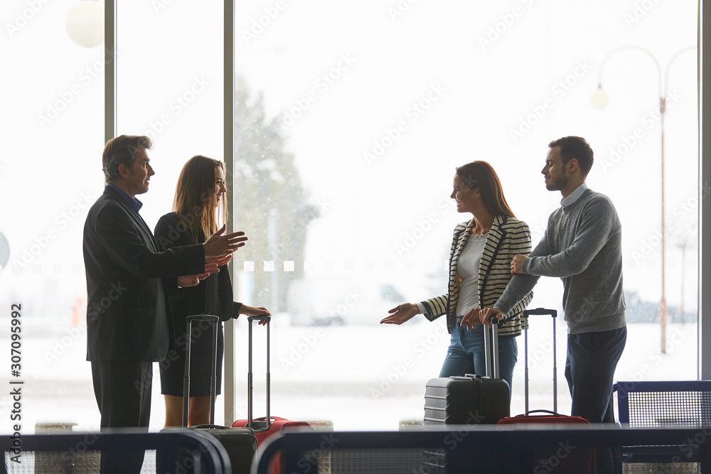 Group of travelers talking in the airport terminal Stock Photo | Adobe ...