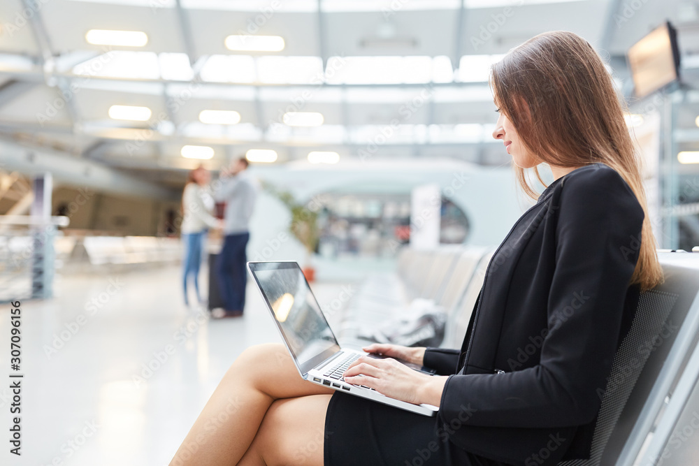 Young businesswoman with laptop computer in the airport Stock Photo ...