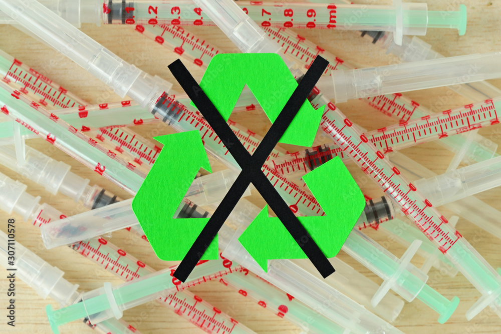 Do Not Recycle Symbol on syringes and needles background - Concept of ...