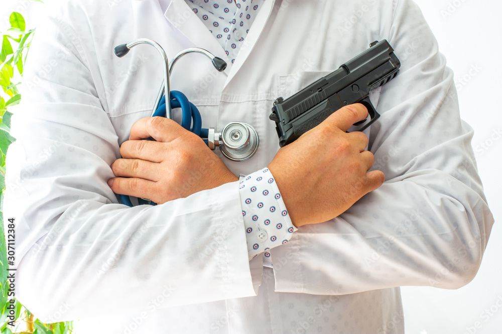 Doctor stands in full height with his arms folded on his breasts and ...