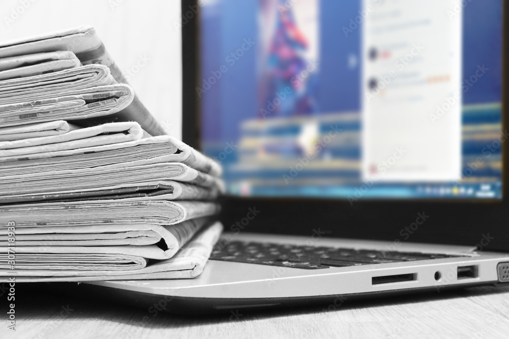 Newspapers and Laptop. Different Concepts for News - Social Network or ...