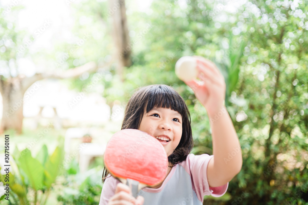5 years old asian girl child holding racket and serve at table tennis ...