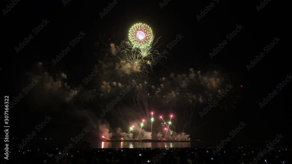 Real fireworks background and people who come to watch on the beach ...