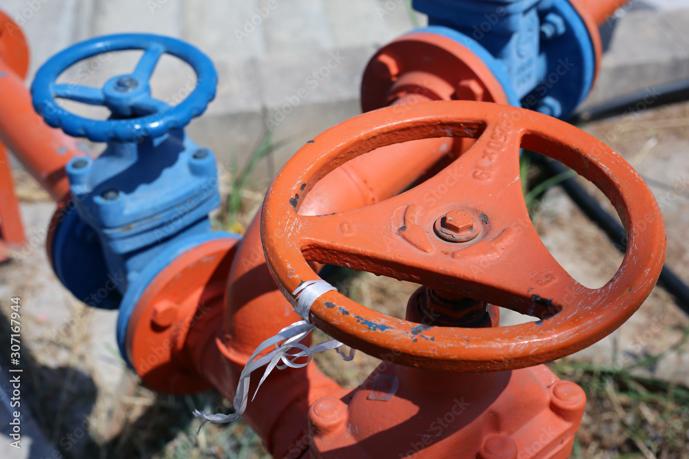 Orange and blue colorful orange and blue water pipes with big vents. In ...